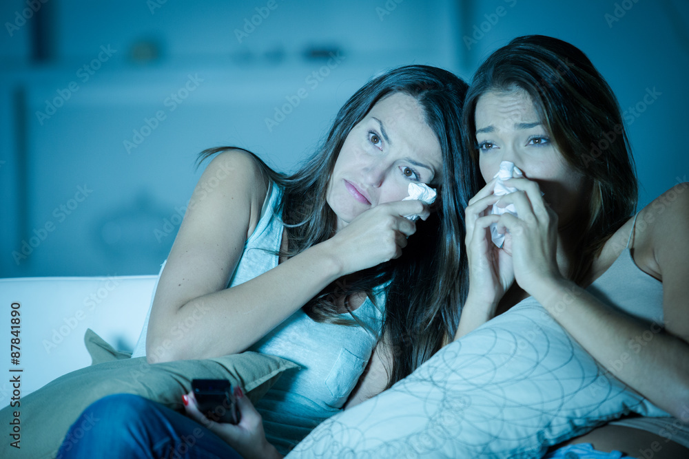 Woman crying whilst watching a movie Stock-Foto | Adobe Stock