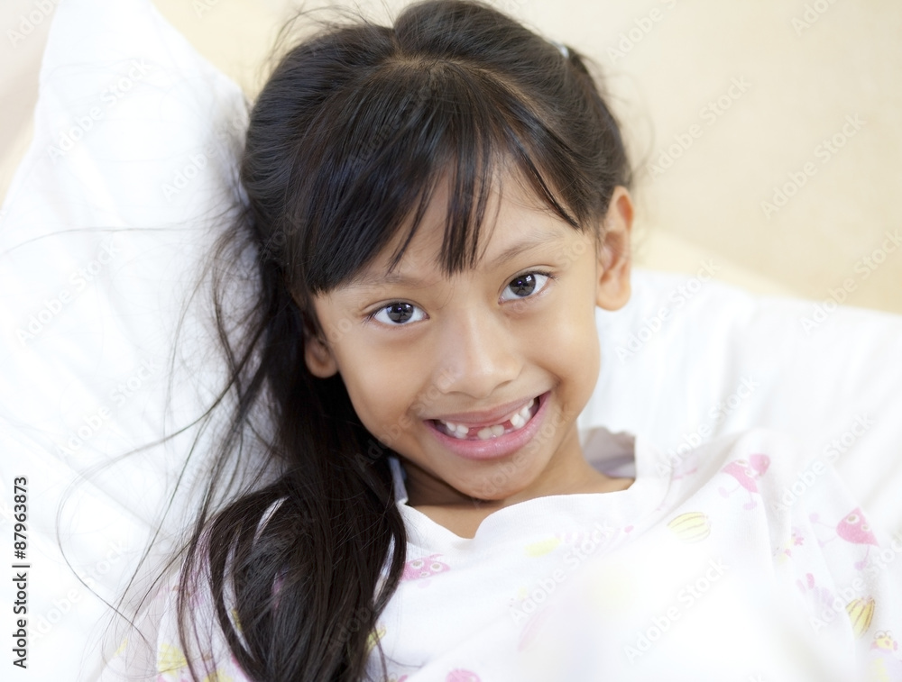 beautiful little girl grinning at the camera showing off her mis Stock ...