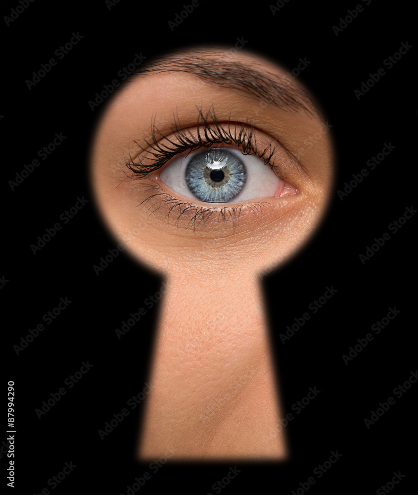 Curious female peeking through a keyhole Stock Photo | Adobe Stock