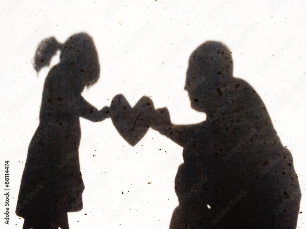 Shadow of a girl handing her father a heart Stock Photo | Adobe Stock