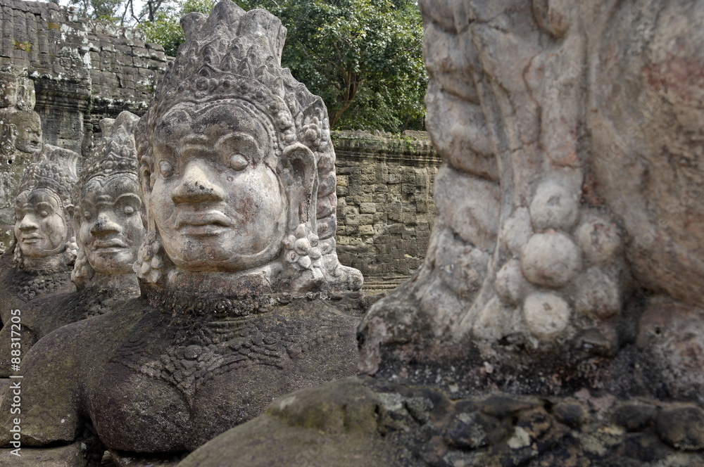 Southern causeway of Angkor Thom, flanked by gods holding scaly body of ...