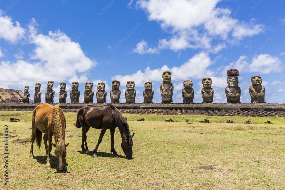 Horses grazing at the 15 moai restored ceremonial site of Ahu Tongariki ...