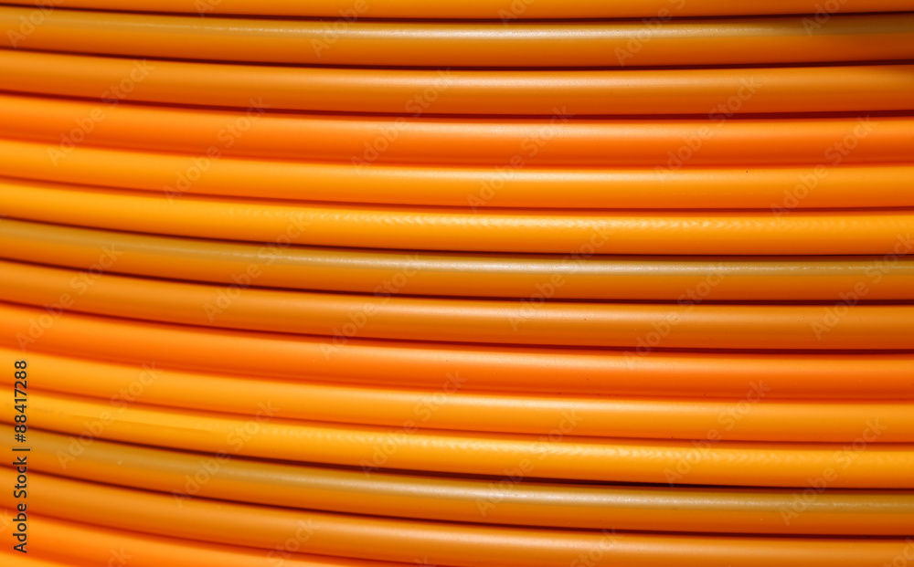 coils of orange plastic pipes for the installation of undergroun Stock ...