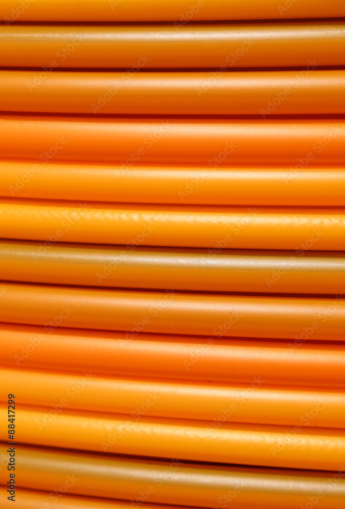 long coils of orange plastic pipes for the installation of opti Stock ...