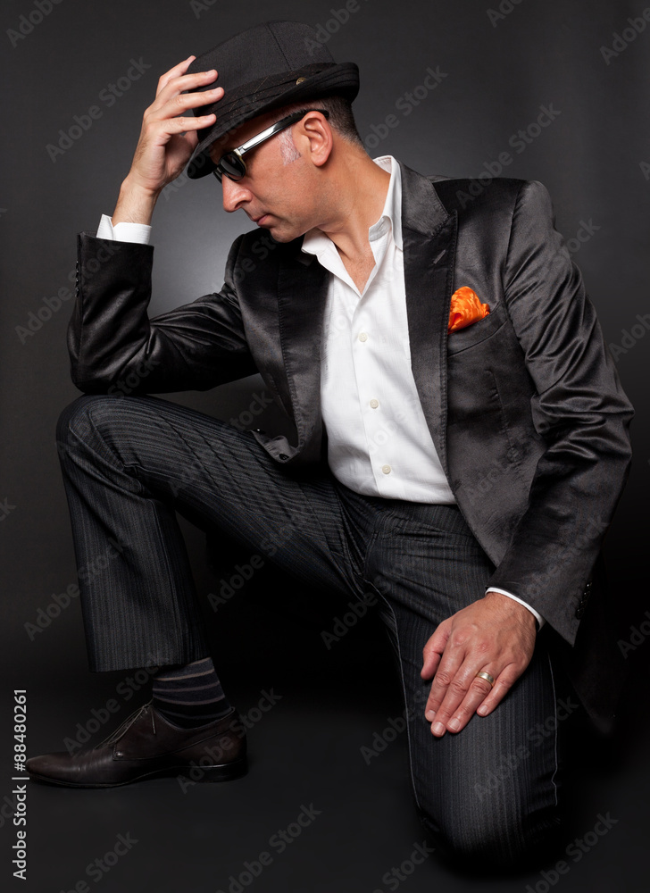 Male model poses in suit with his fedora Stock Photo | Adobe Stock