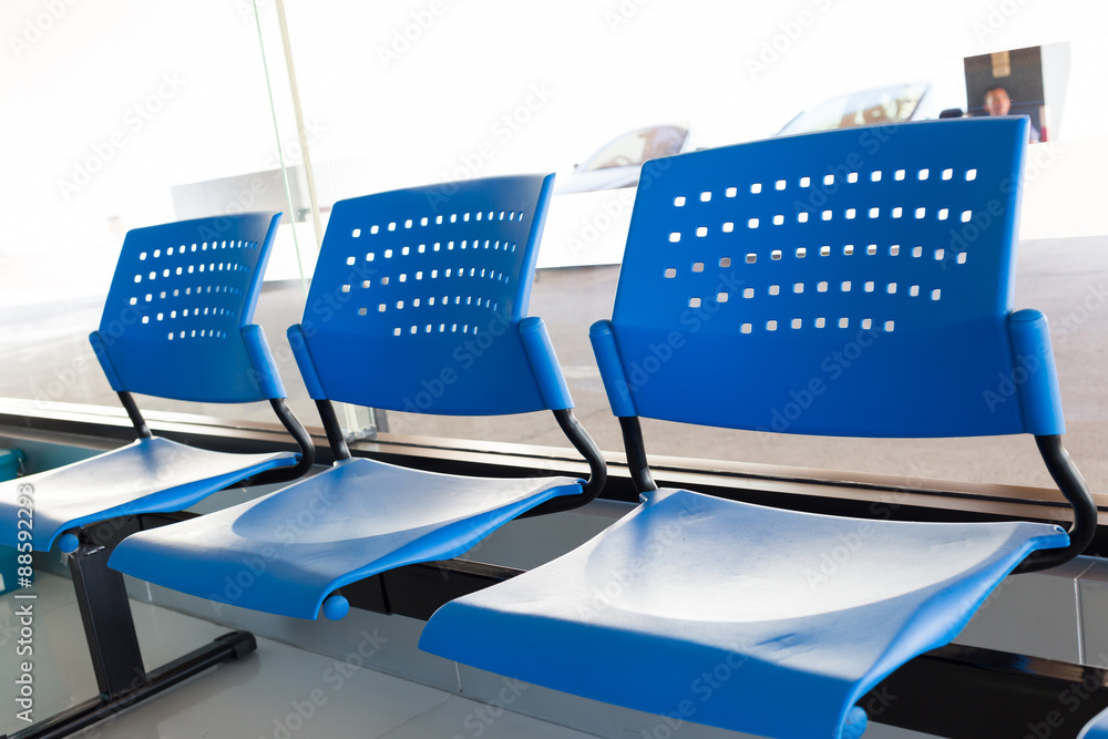 customer waiting area with rows of blue seats in office Stock Photo ...