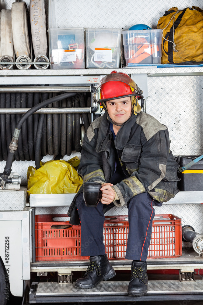 Confident Fireman Holding Coffee Mug In Truck Stock Photo | Adobe Stock