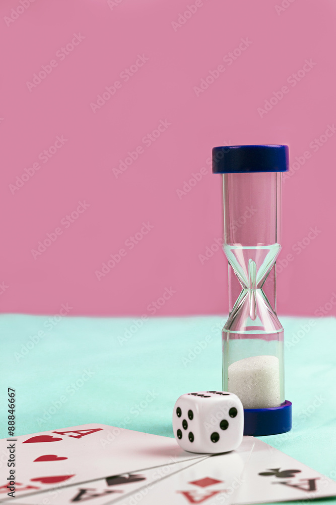 Playing Cards with Blue Sand Timer and Die on Blue and Pink Back Stock ...