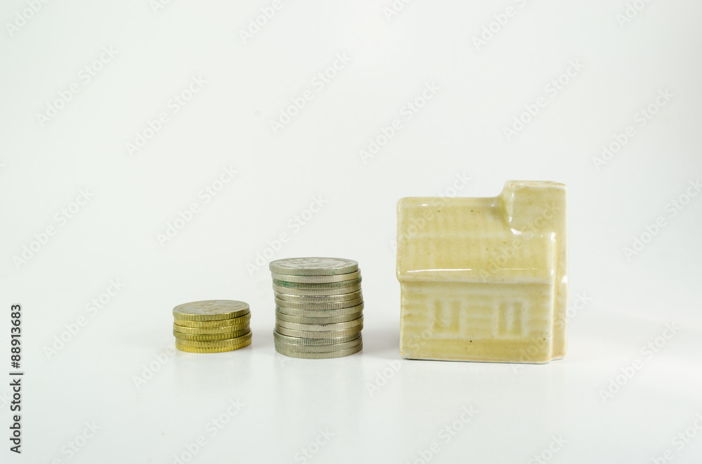 Stacked Malaysian Ringgit coins leading to miniature dream house ...