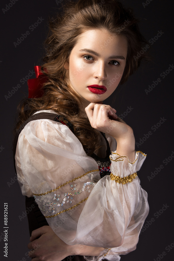 Beautiful Russian girl in national dress with a braid hairstyle and red ...