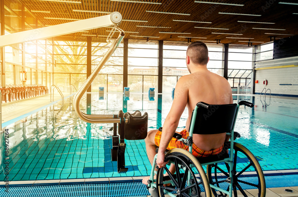 Disabled man in a swimming pool. Wheelchair. Disabled man in a ...