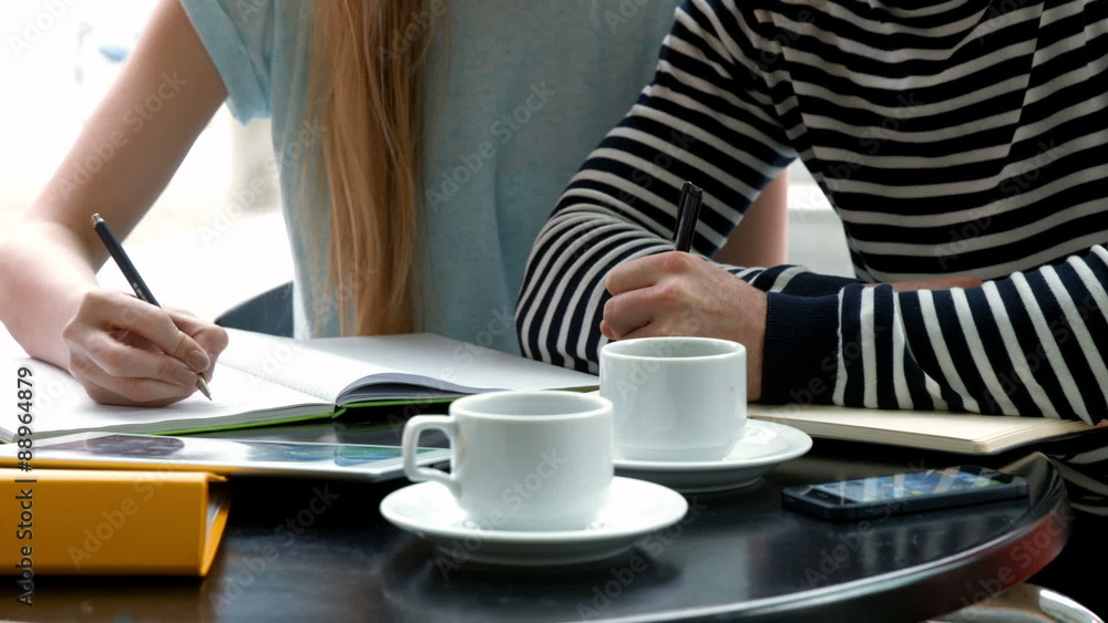 Students working on assignment at campus cafe Stock Video | Adobe Stock