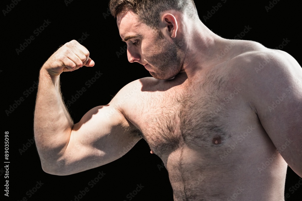 Strong bodybuilder flexing his bicep Stock Photo | Adobe Stock