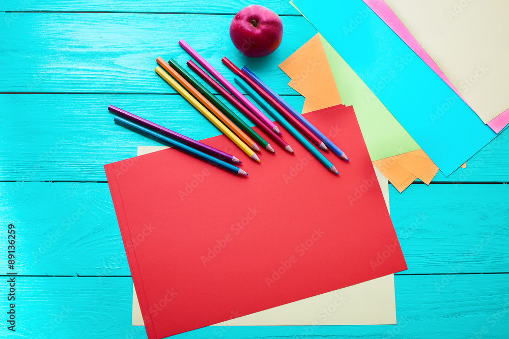 Desk of an artist with lots of stationery objects on blue wooden ...
