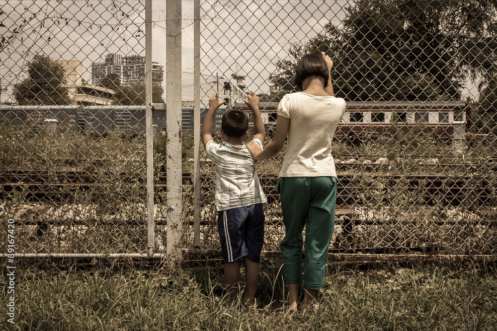 asian girl and boy sad hand hold jail at Railroad,railway stati Stock ...