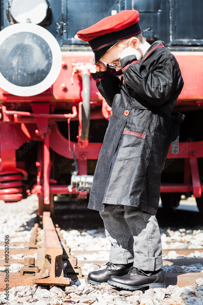 Interruption of Journey / Nostalgic little child boy railroad conductor ...