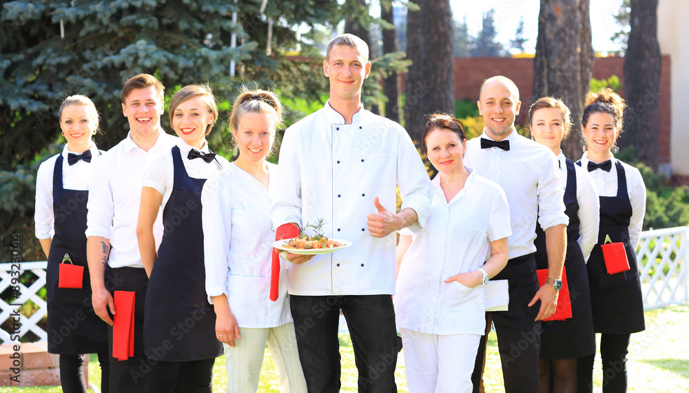 Large group of waiters and waitresses standing in row. Stock Photo ...