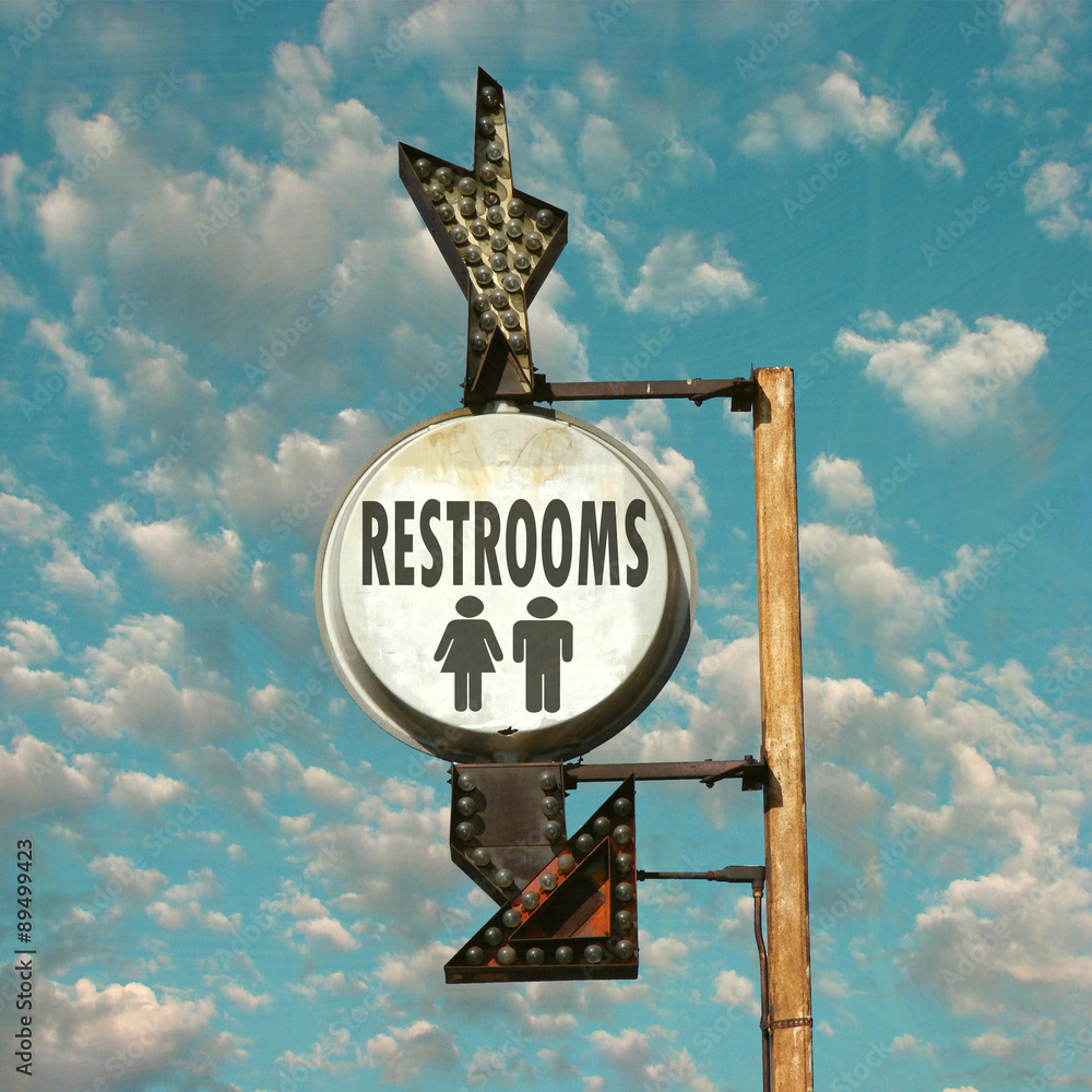 aged and worn vintage photo of restroom sign with arrow Stock Photo ...
