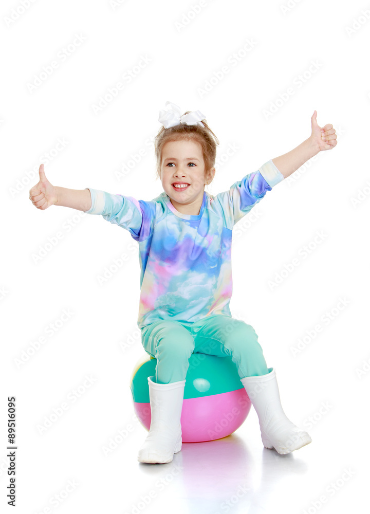 Girl sitting on the ball Stock Photo | Adobe Stock