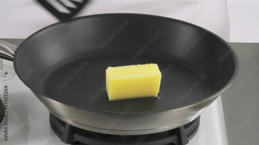 Melting butter in a frying pan Stock Video | Adobe Stock