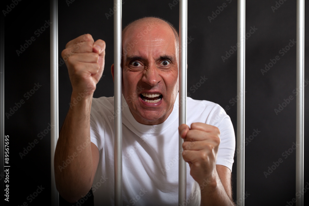 Angry man in prison Stock Photo | Adobe Stock