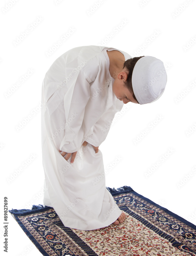 Muslim young boy praying on a carpet isolated on white background Stock ...