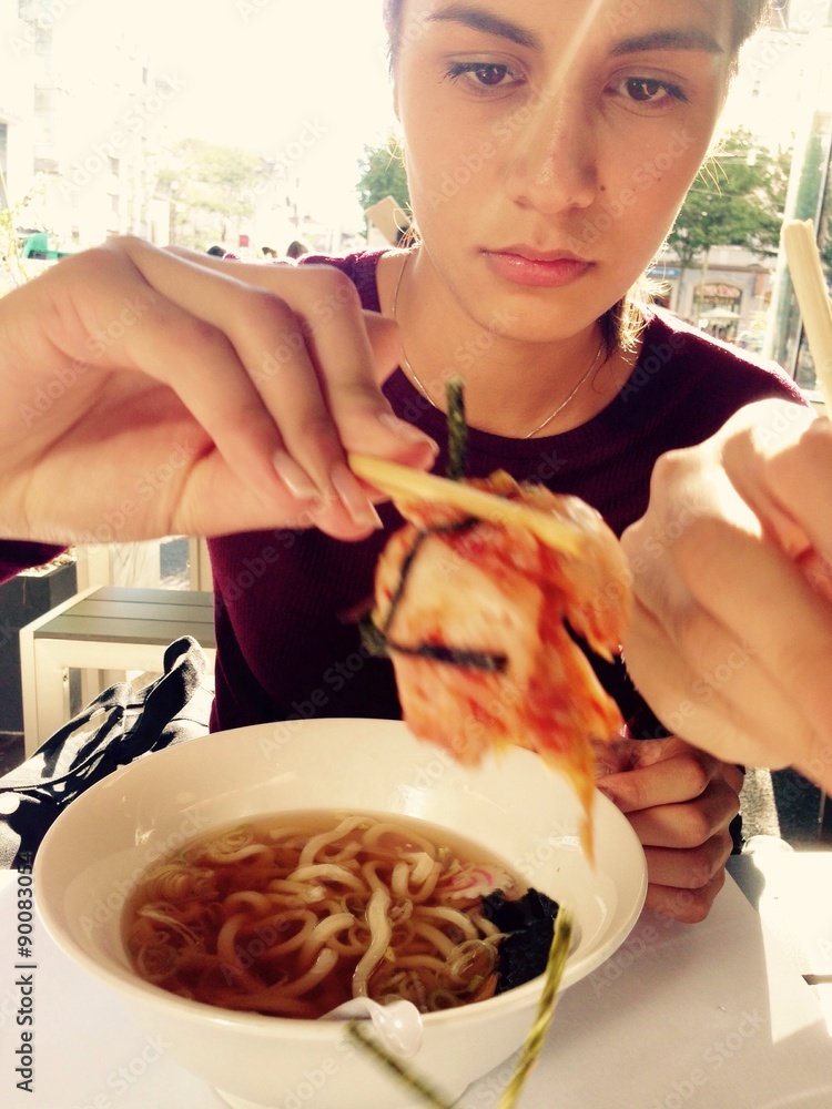 teenage girl eating kimchi Stock Photo | Adobe Stock