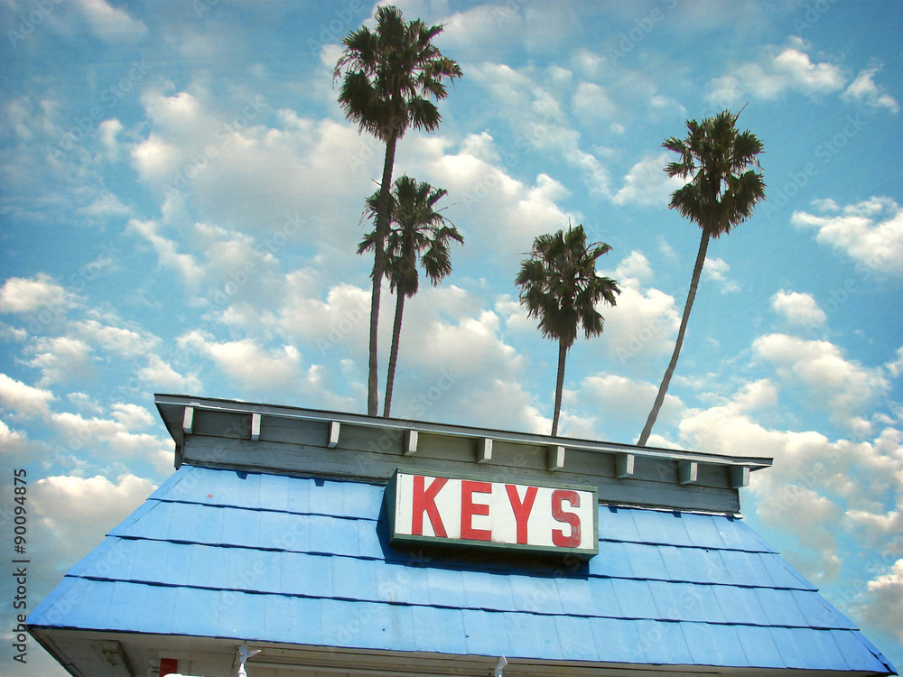 aged and worn vintage photo of key shop with palm trees Stock Photo ...