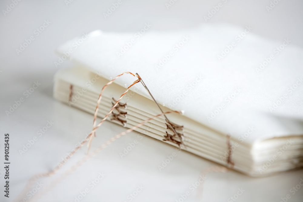 Needle And Notepad Papers On Table Stock Photo | Adobe Stock
