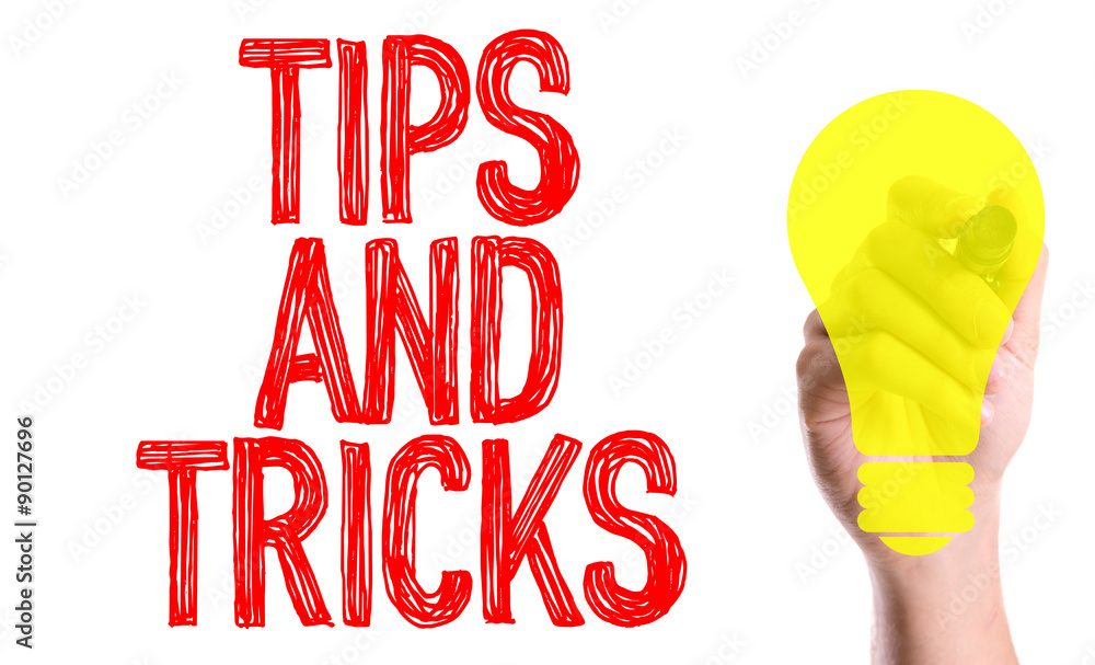 Hand with marker writing the word Tips and Tricks Stock Photo | Adobe Stock
