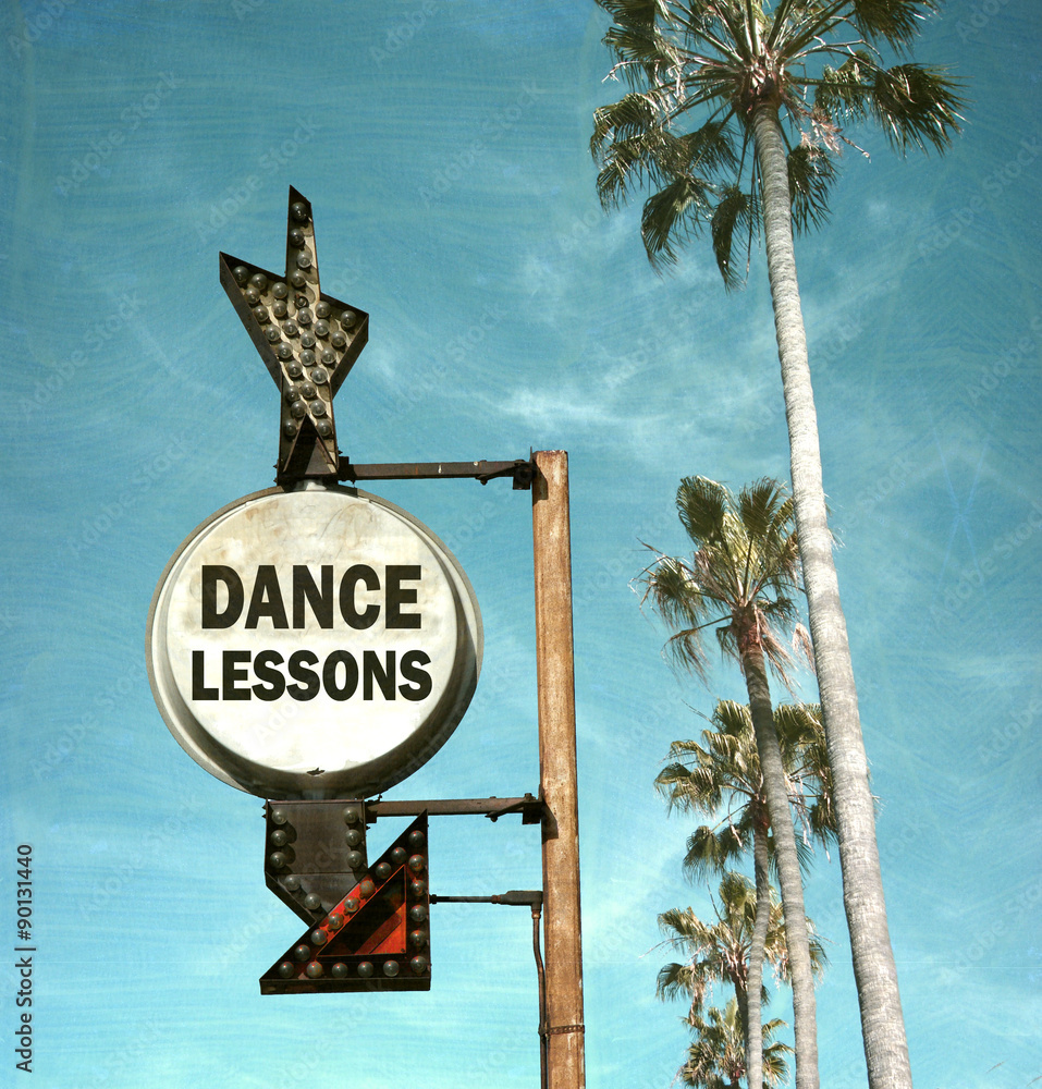 aged and worn vintage photo of dance lesson sign and palm trees foto de ...