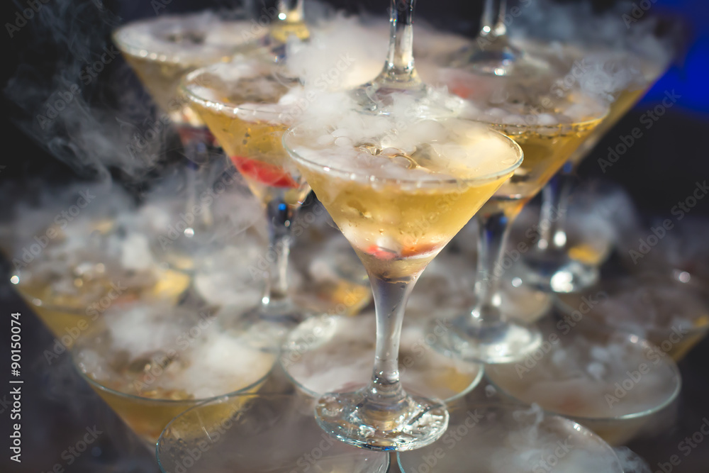 Beautiful row line of different colored alcohol cocktails with mint on ...