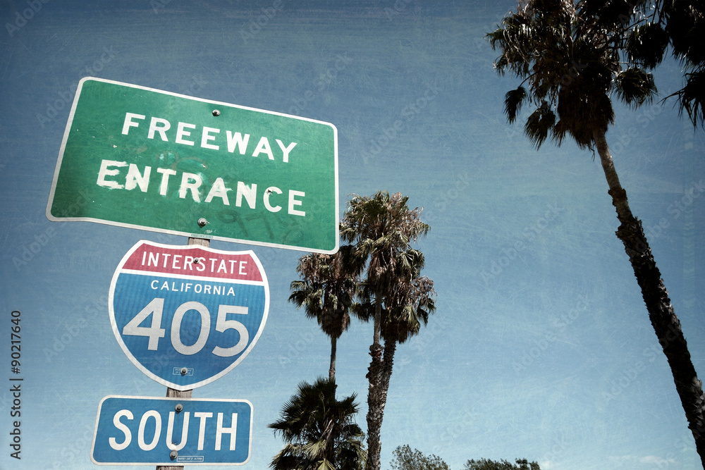 aged and worn vintage photo of freeway sign with palm trees Stock Photo ...