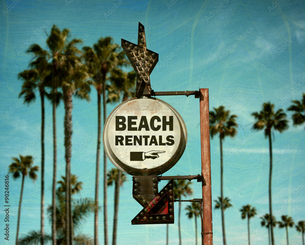aged and worn vintage photo of beach rentals sign with palm trees Stock ...