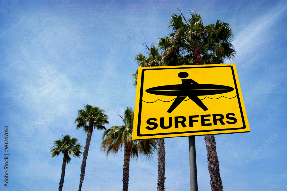 aged and worn vintage photo of surfers sign on beach with palm trees ...