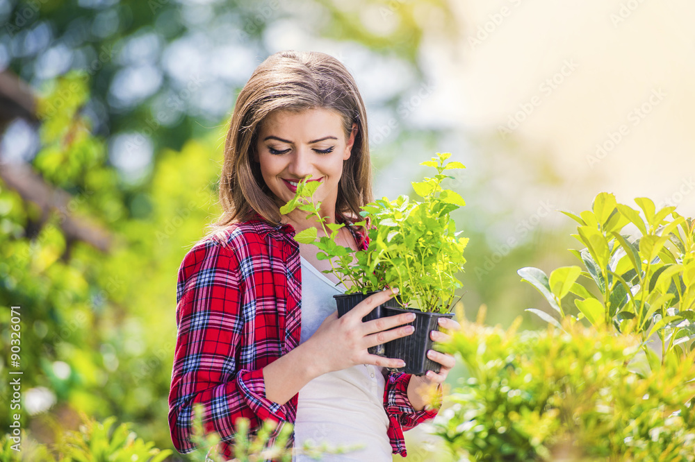 Beautiful young woman gardening Stock Photo | Adobe Stock