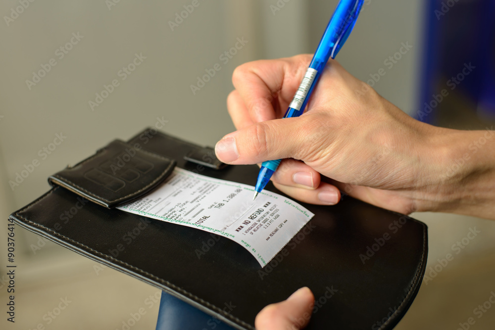 Consumer signing on a sale transaction receipt Stock Photo | Adobe Stock