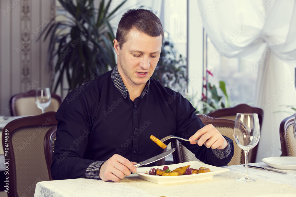 young man having dinner in a restaurant Stock Photo | Adobe Stock