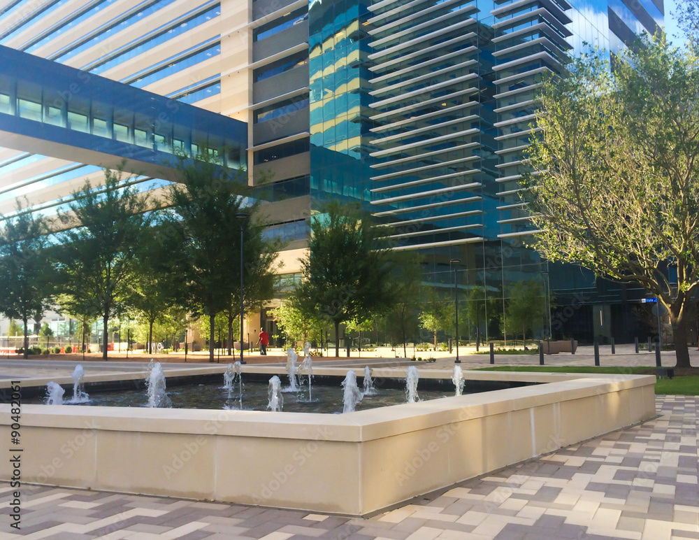 Modern office building with sky bridge and landscaped campus courtyard ...