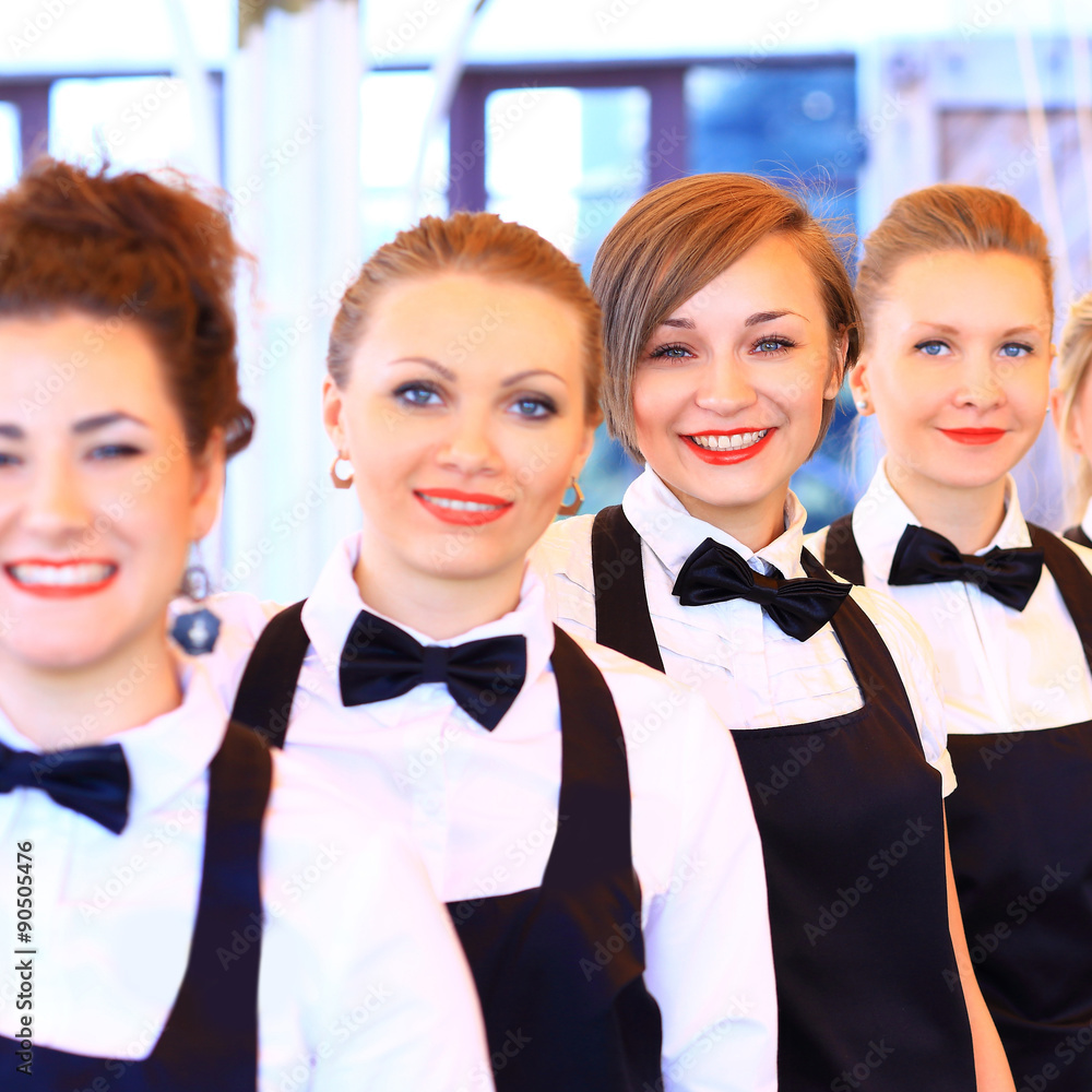 Large group of waiters and waitresses standing in row. Stock Photo ...