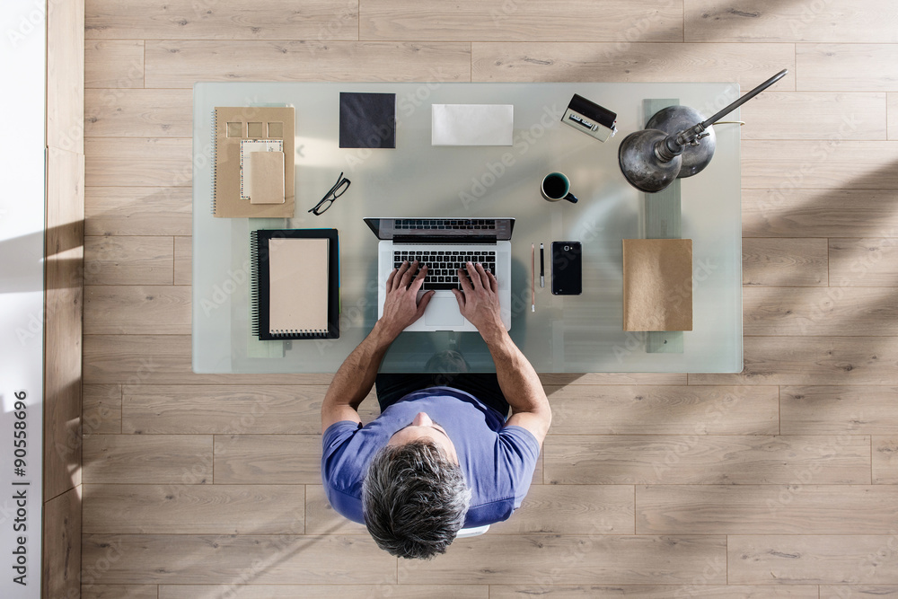 top view, a man sitting at tidy desk and working on his laptop Stock ...