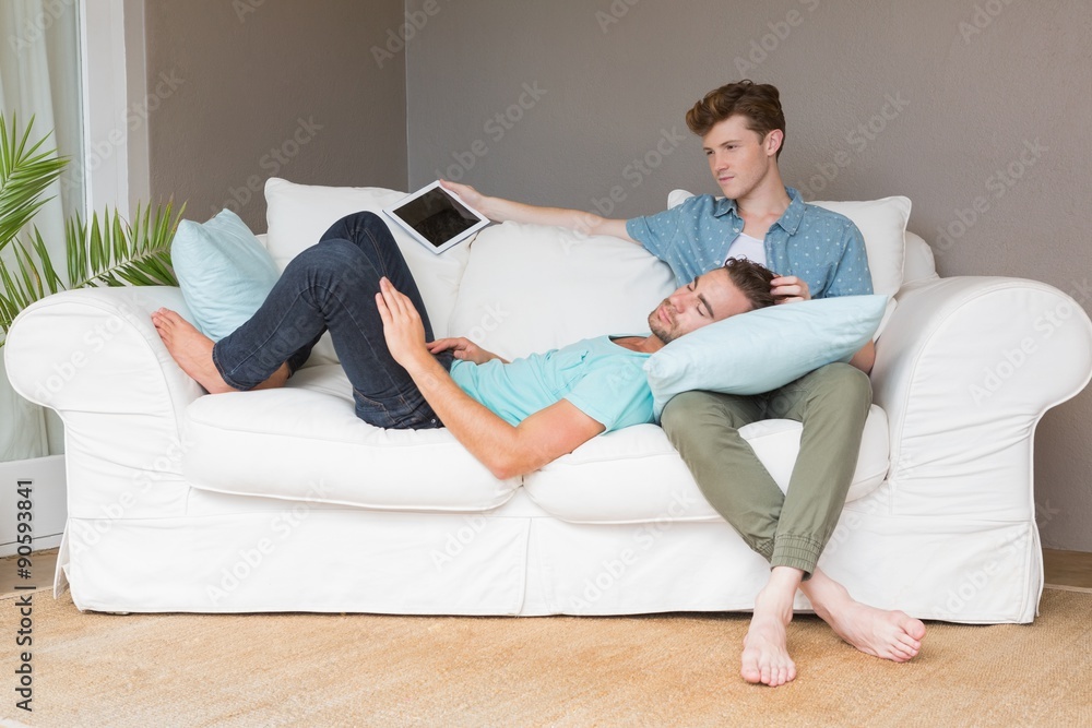 Handsome man sleeping on couch while his boyfriend is siting Stock ...