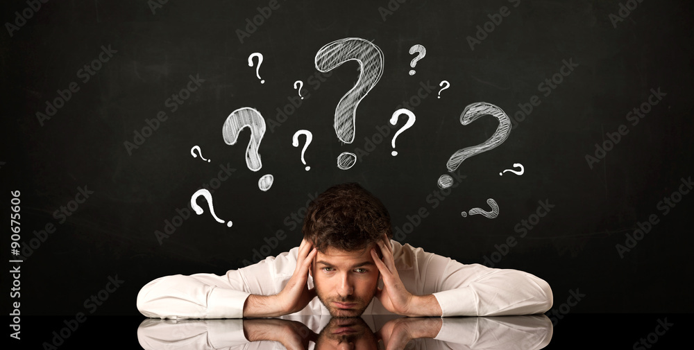Sitting businessman under question marks Stock Photo | Adobe Stock