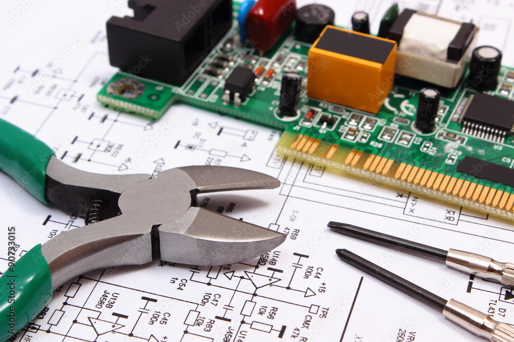 Printed circuit board and precision tools on diagram of electronics ...