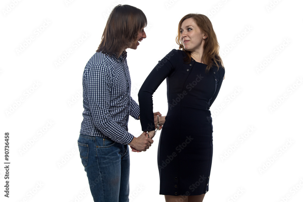 Smiling man and woman with pair of handcuffs Stock Photo | Adobe Stock