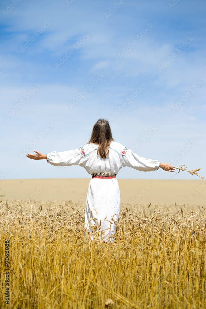 Picture of female in traditional dress standing hands up to sky Stock ...