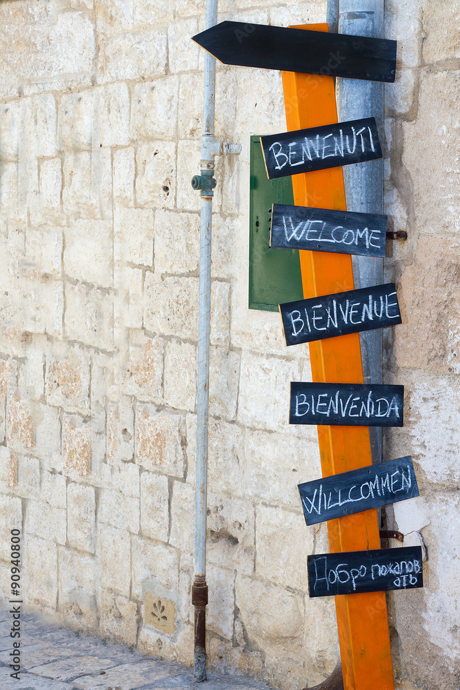 Welcome sign with arrows in multiple languages Stock Photo | Adobe Stock