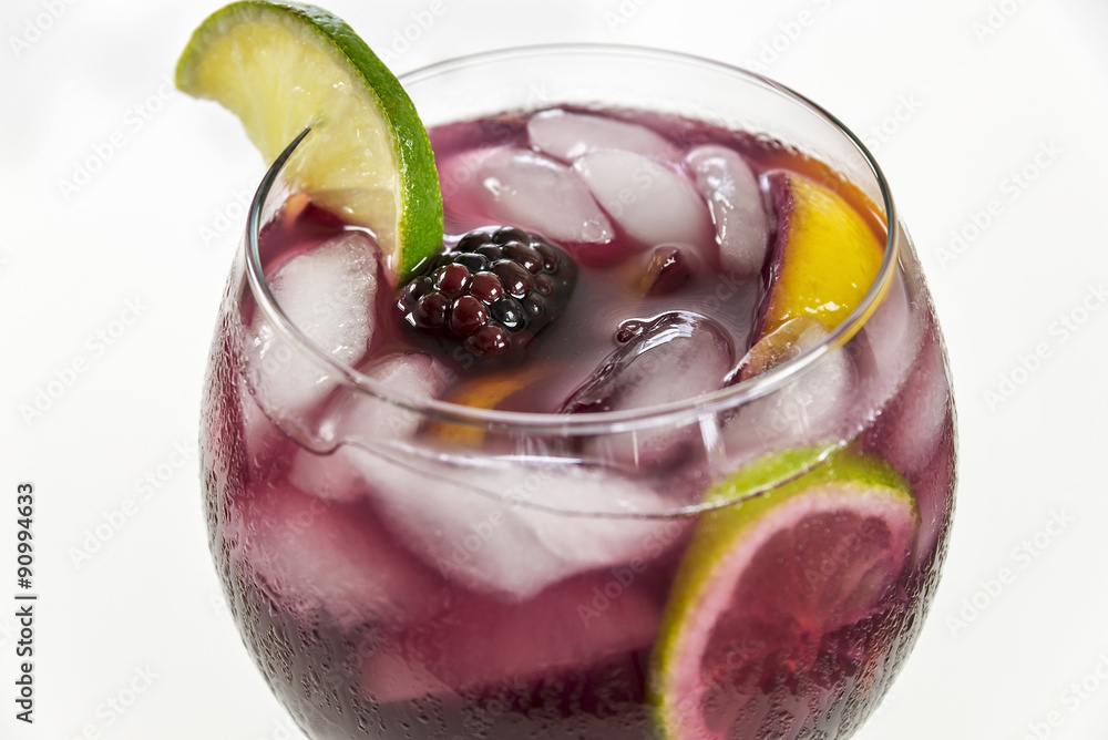 A large wine glass full of refreshing fruit filled red sangria on a ...