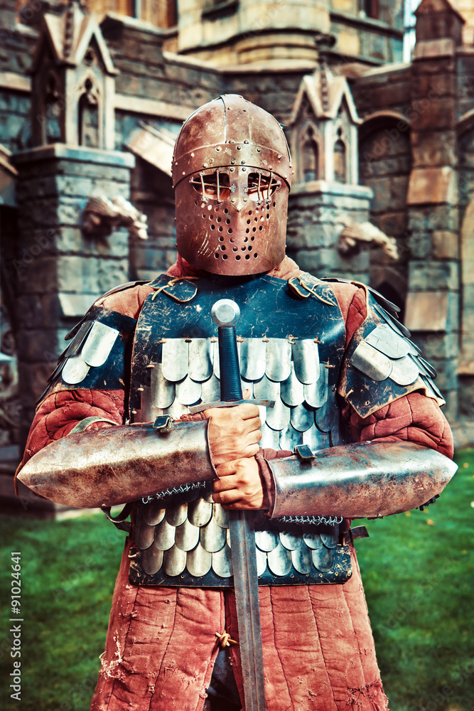 Medieval knight with the sword on the ancient castle background Stock ...