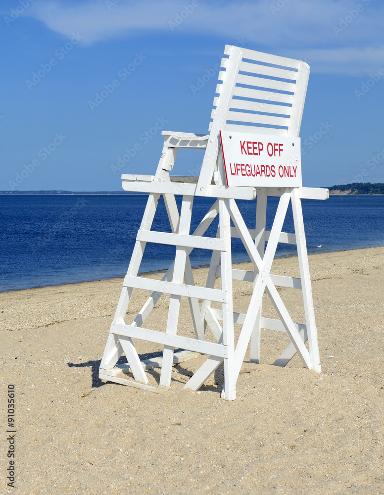 White lifeguard chair on empty sand beach with blue sky Stock Photo ...